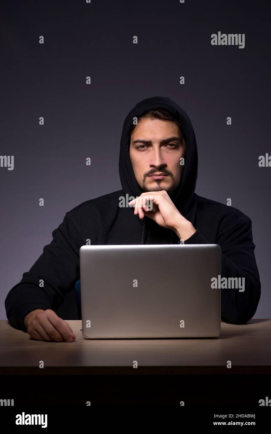 Young hacker on grey background Stock Photo - Alamy