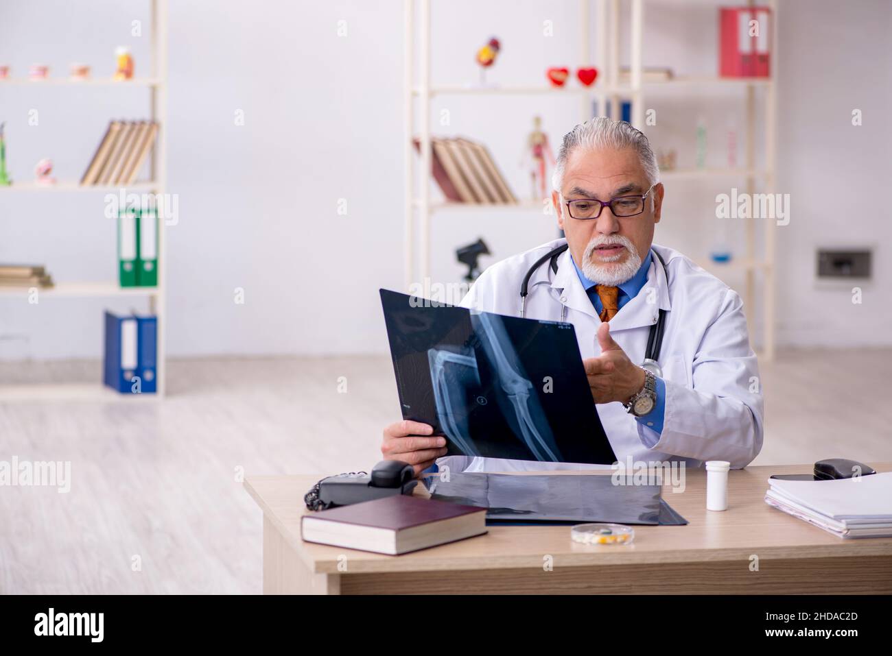 Old doctor radiologist working in the clinic Stock Photo - Alamy
