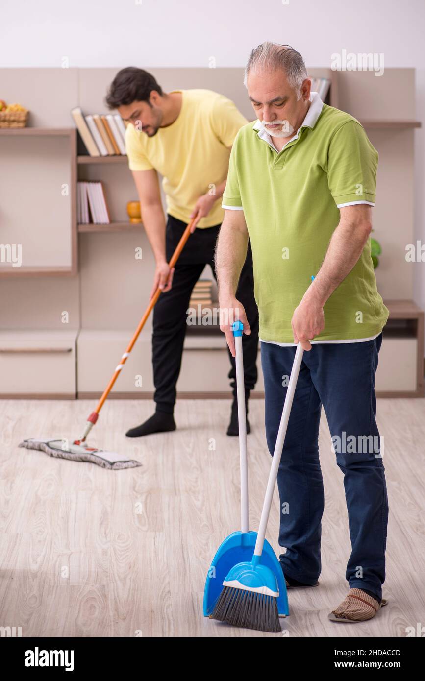 Two contractors cleaning the house Stock Photo - Alamy