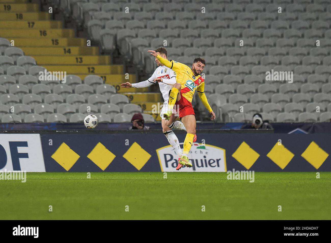 Lens' Jonathan Clauss (R) figths for the ball with Lille's Johan ...