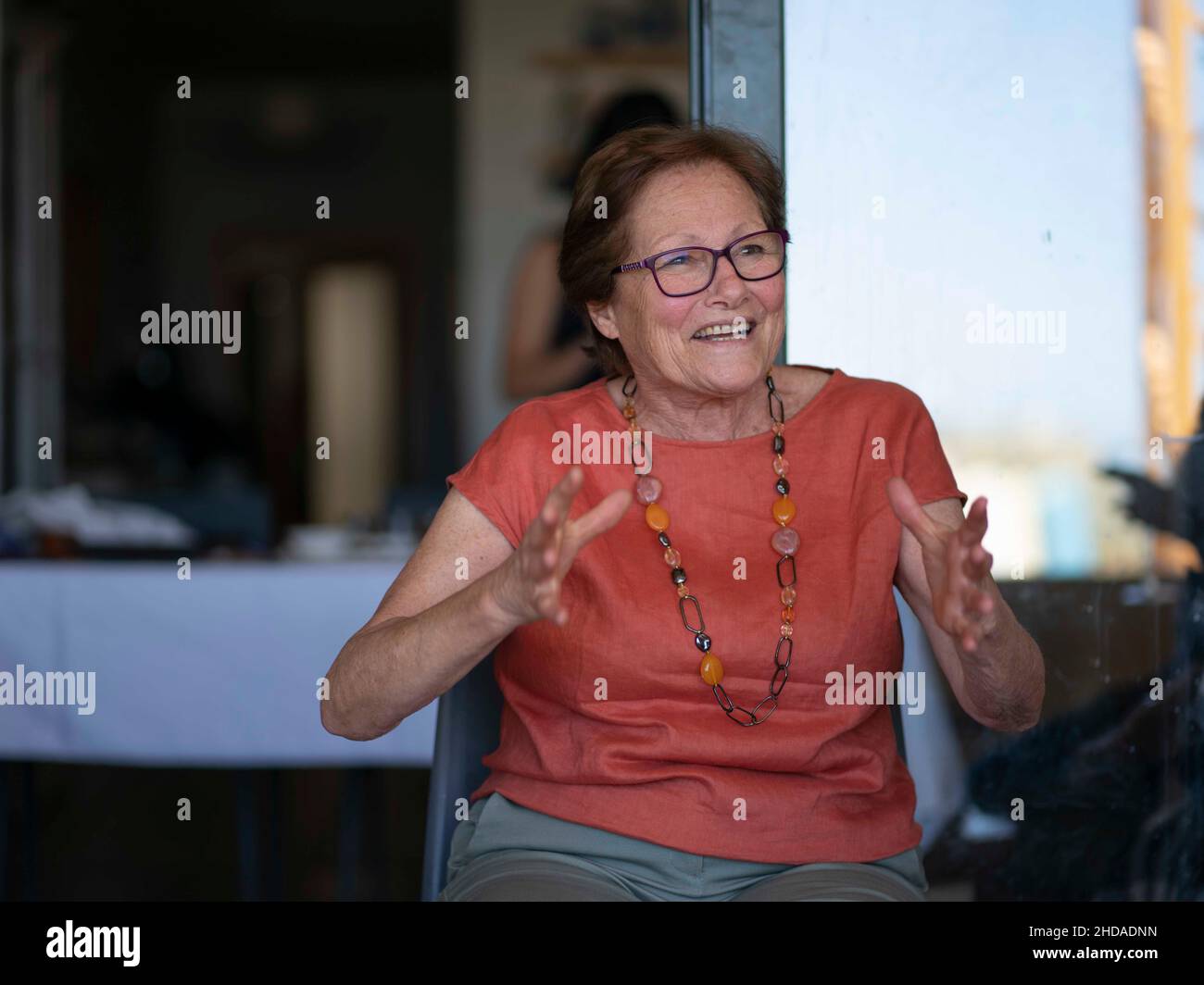 Elderly aged woman using hands to explain Stock Photo - Alamy