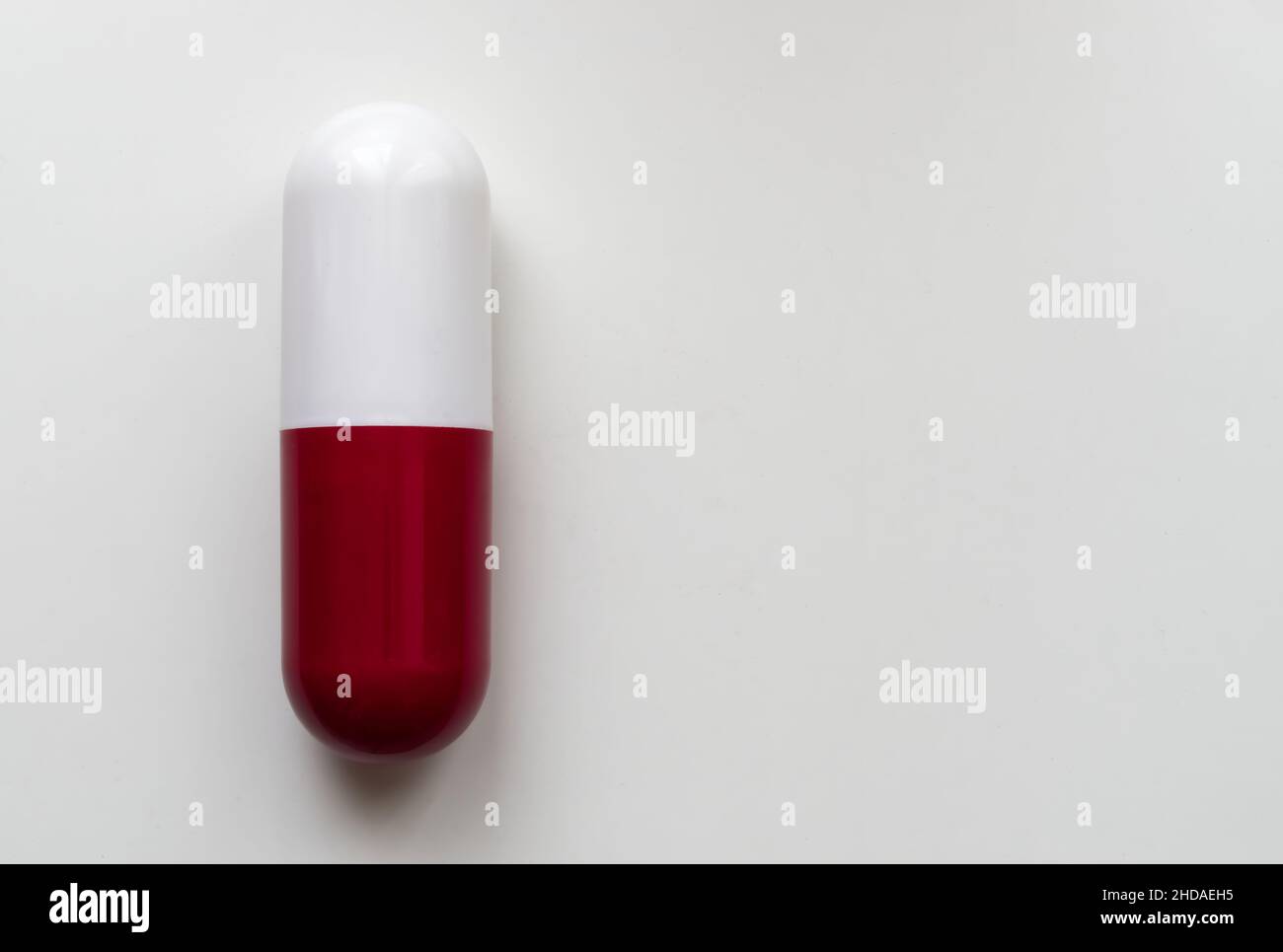 Big red and white capsule pill isolated on white background. Pharmacy ...