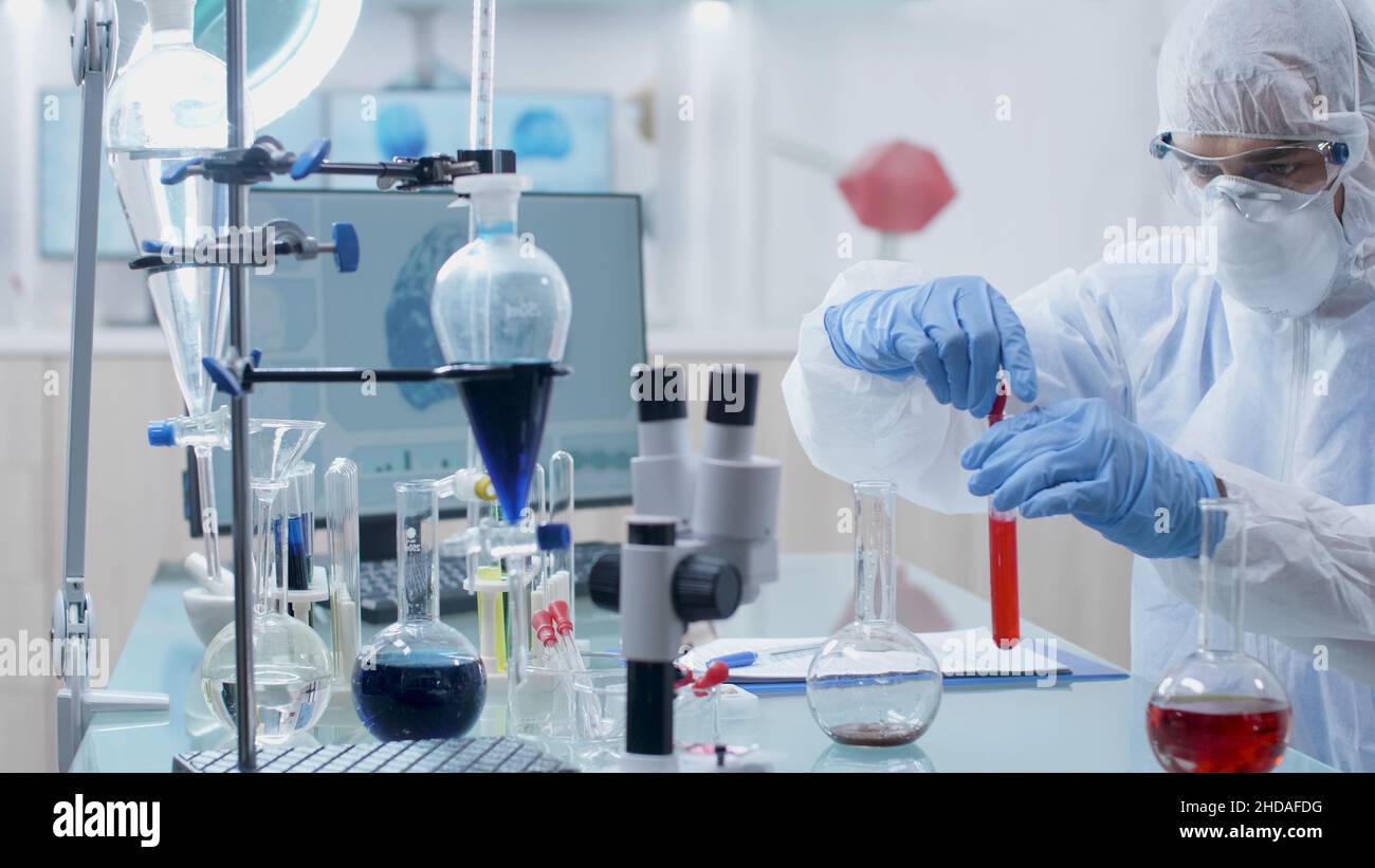 Microbiologist researcher with ppe equipment working with medical ...
