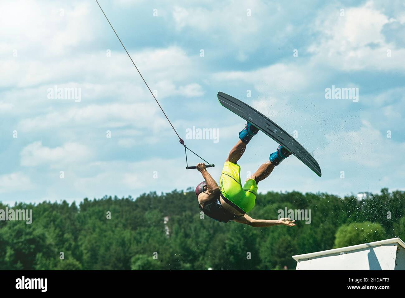 young active professional athlete jumping in the air on a wakeboard ...