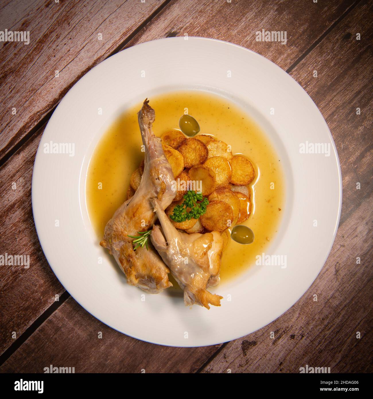 Rabbit casserole recipe with olives and herbs, sauteed potatoes Stock ...