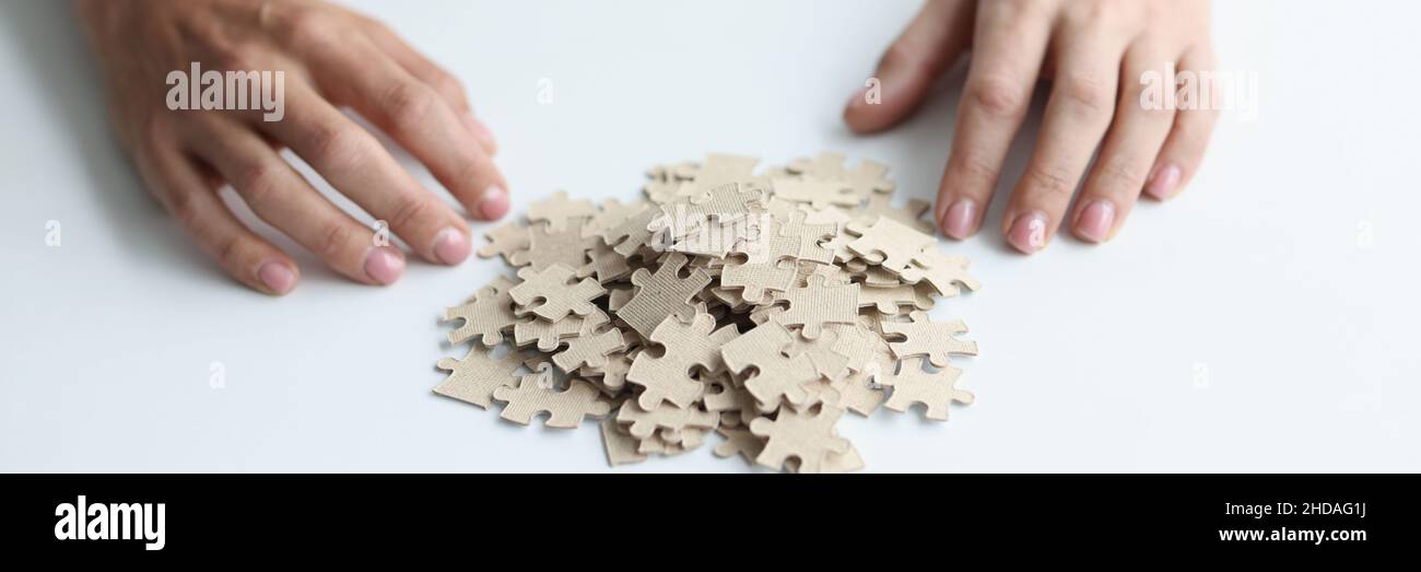 Decomposition of puzzles and female hands on table closeup Stock Photo ...