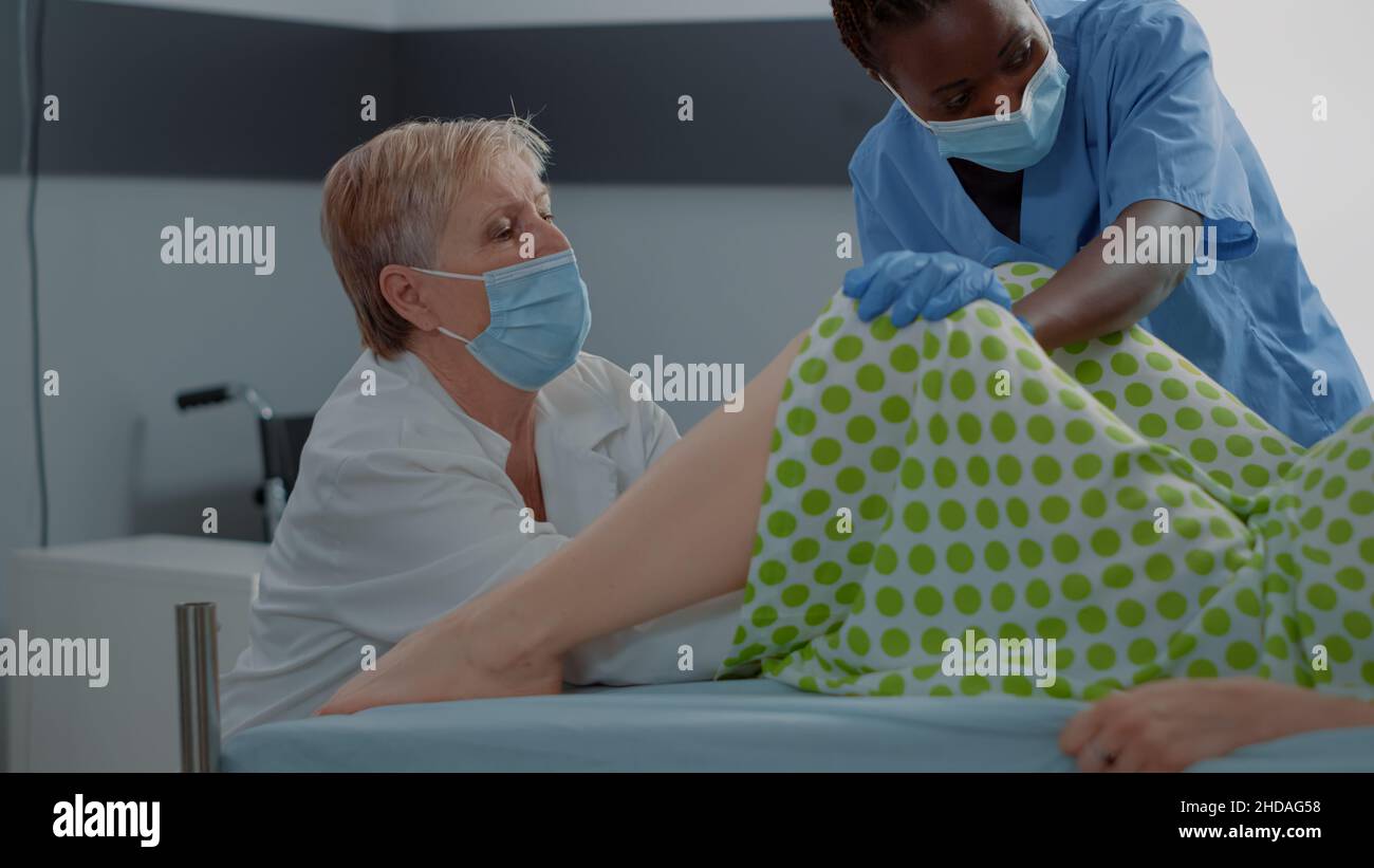 Close up of childbirth doctor delivering baby for young woman laying in ...