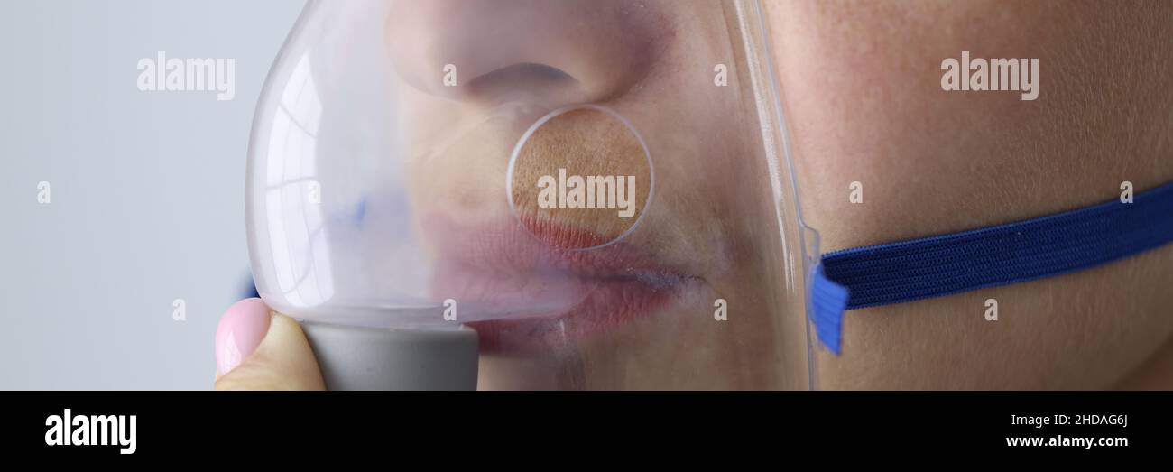 Portrait of woman breathing in oxygen mask closeup Stock Photo - Alamy