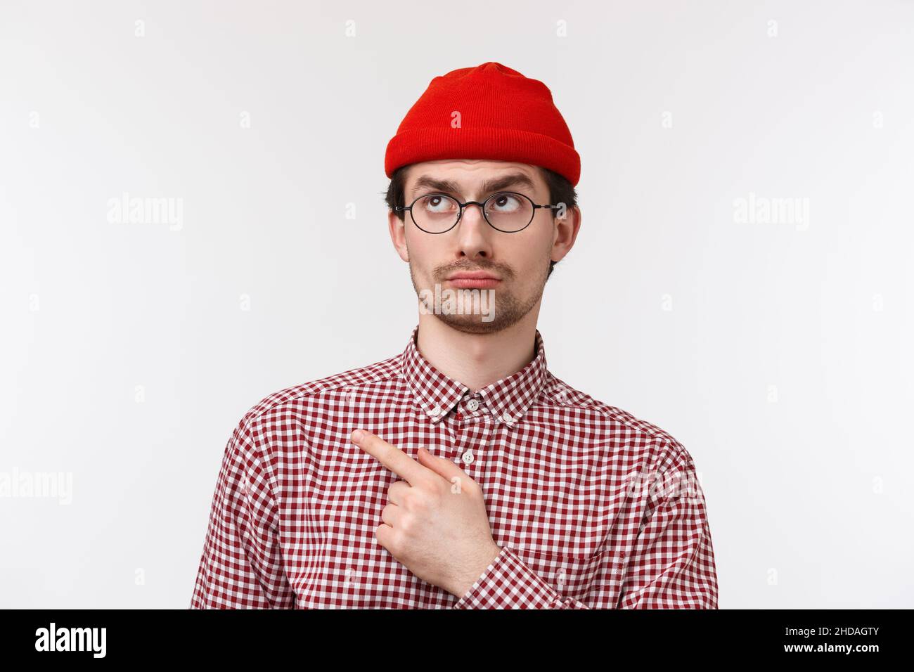 Skeptical and unimpressed handsome young hipster guy look judgemental ...