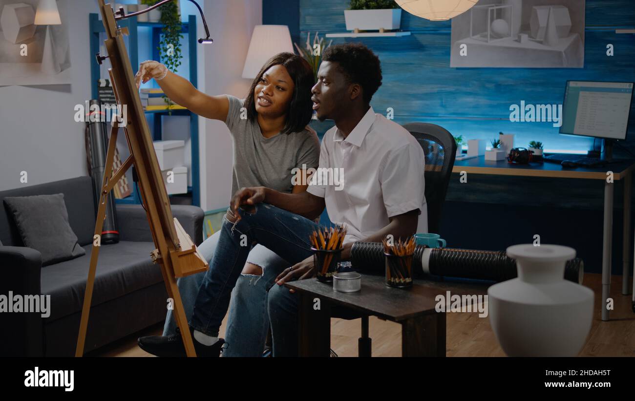 Couple of african american ethnicity working on art masterpiece in ...