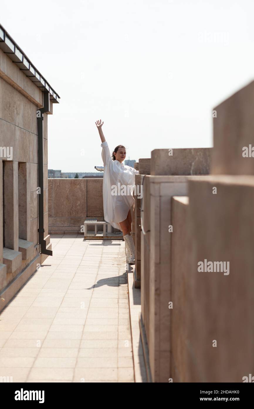Woman standing on roof rising hi-res stock photography and images - Alamy