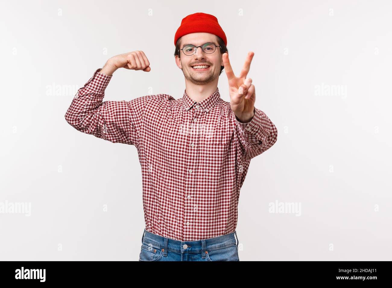 Waist-up portrait young carefree smiling man in glasses and beanie ...