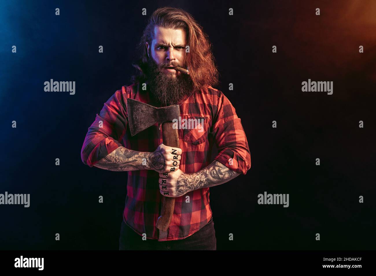 Handsome man with old axe. Bearded lumberjack. Serious brutal male in ...