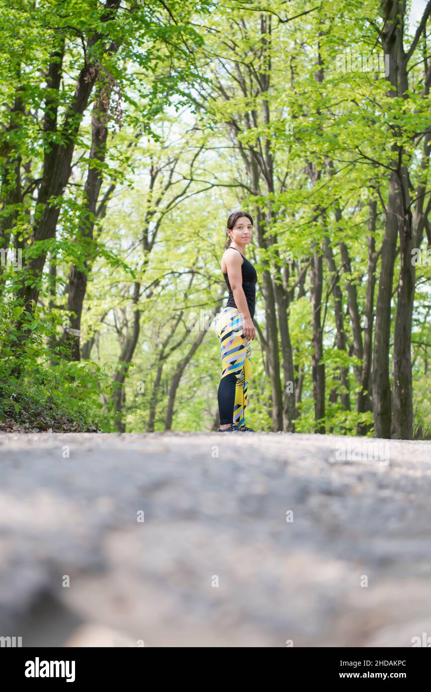 Female standing in the spring trail during her open air training Stock ...