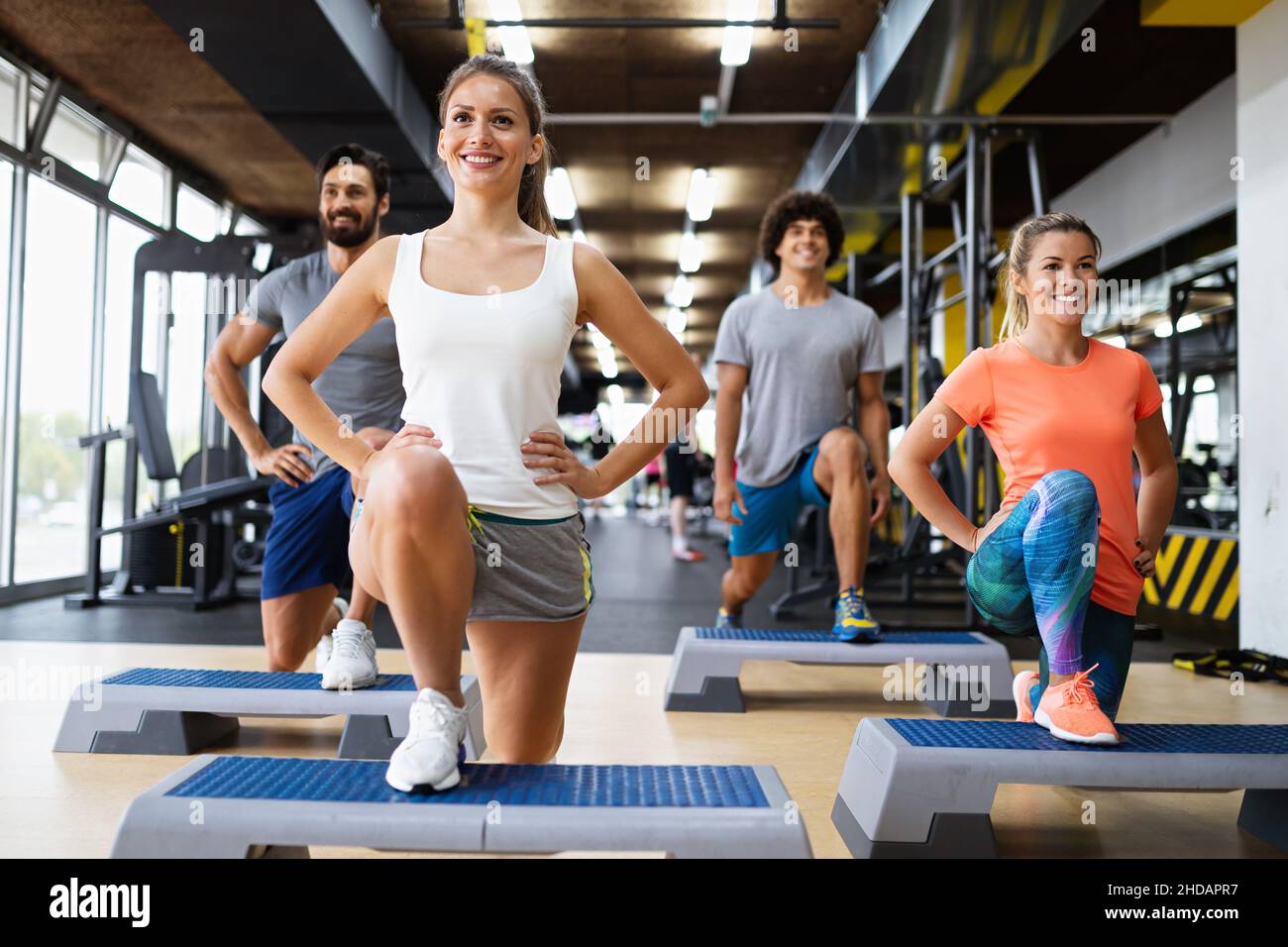 Portrait of happy fit people, friends exercising in gym together. Sport ...