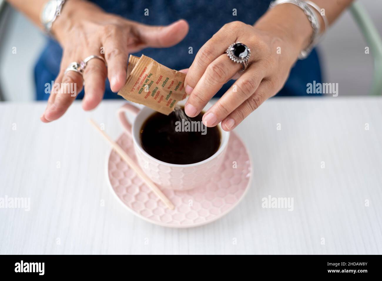 Two hands with a cup of black coffee Stock Photo - Alamy