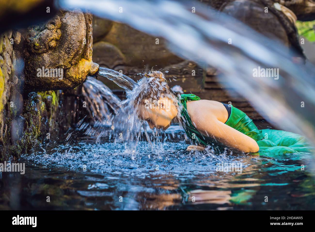 Woman in holy spring water temple in bali. The temple compound consists ...