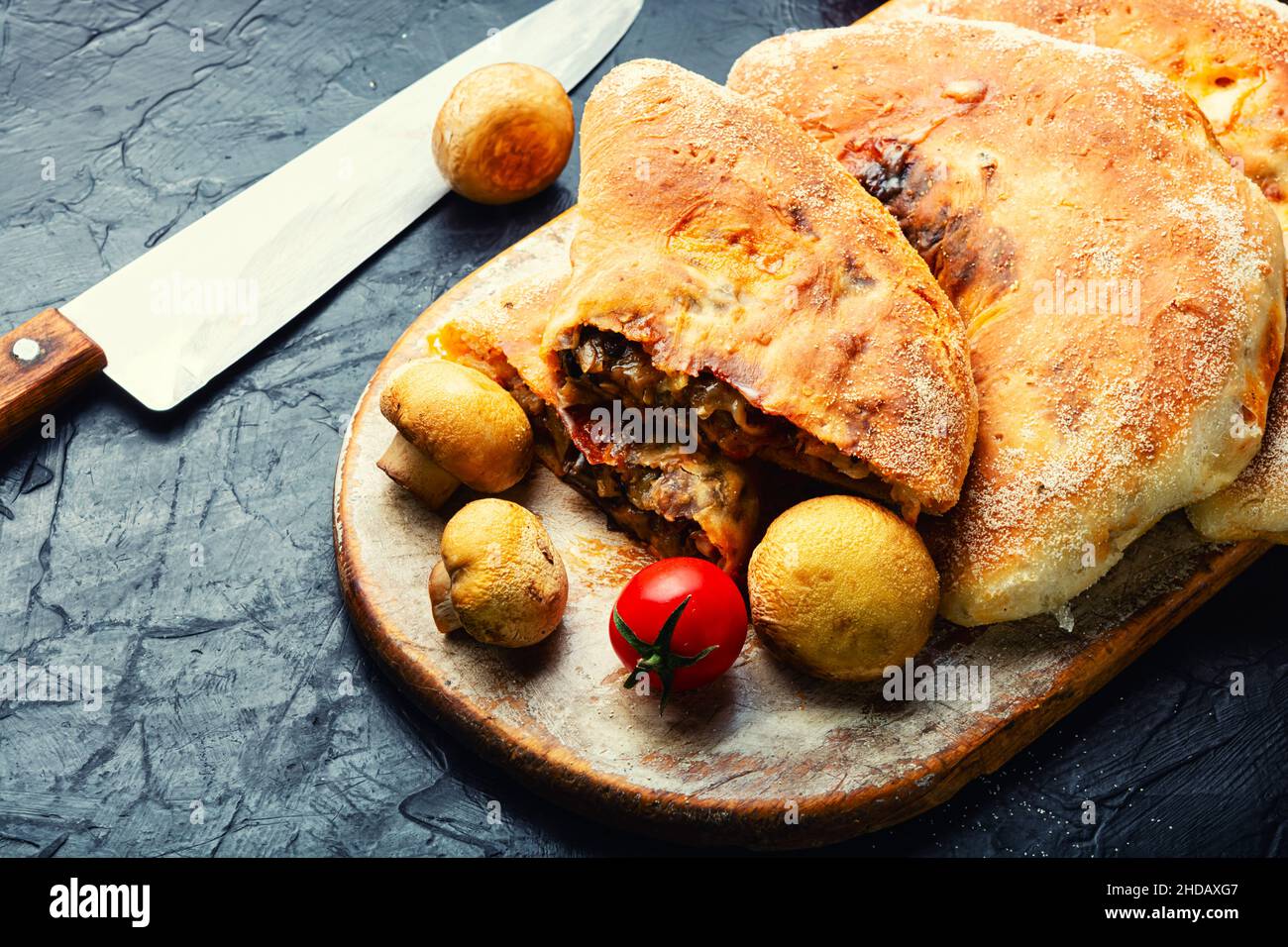 Calzone, a closed pie with vegetable filling. Dish of italian cuisine ...