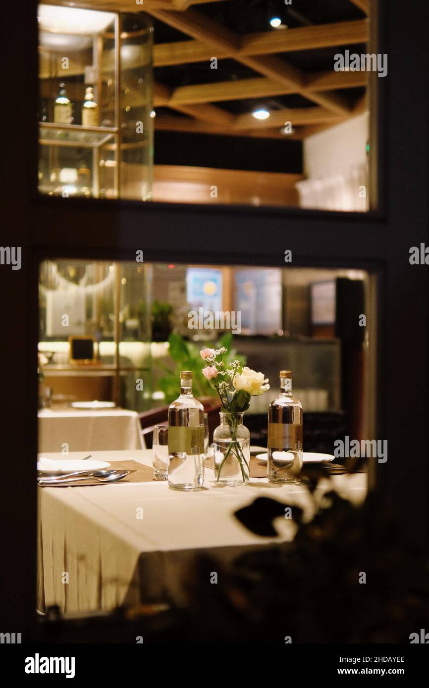 A vertical view of a beautiful dinner date table in a restaurant ...