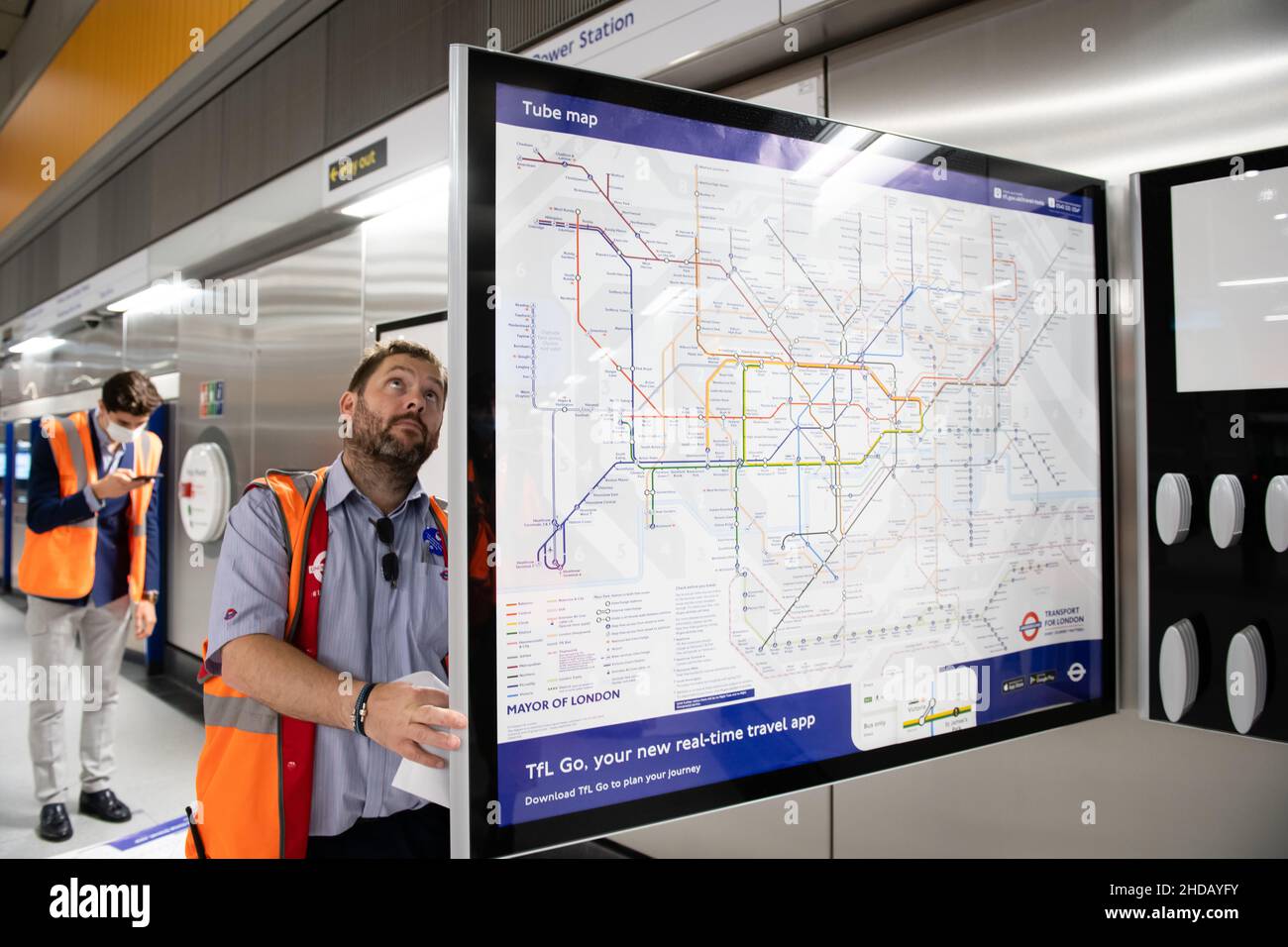 London Underground staff installing new rail and tube maps at Battersea ...