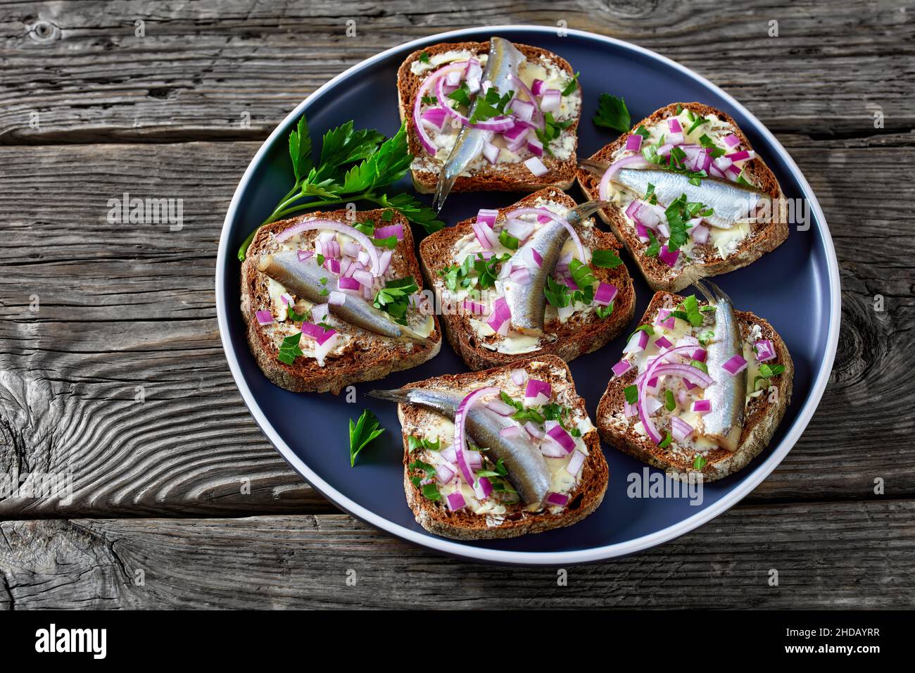 pickled sprat open sandwiches with butter and red onion on rye bread ...