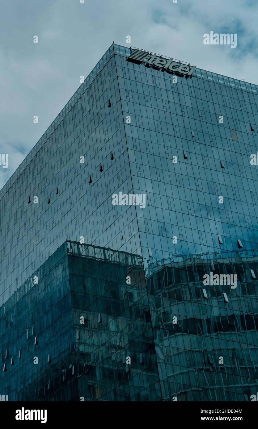 Low-angle shot of a modern glass window building with Telcel mobile ...