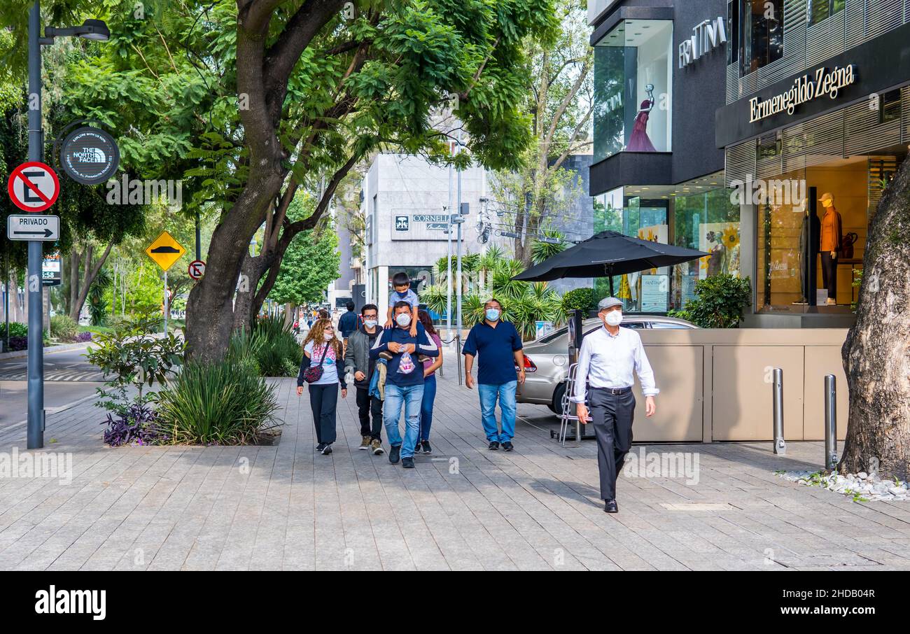 Urban shot of a crowd of people shopping in the upscale neighborhood of ...