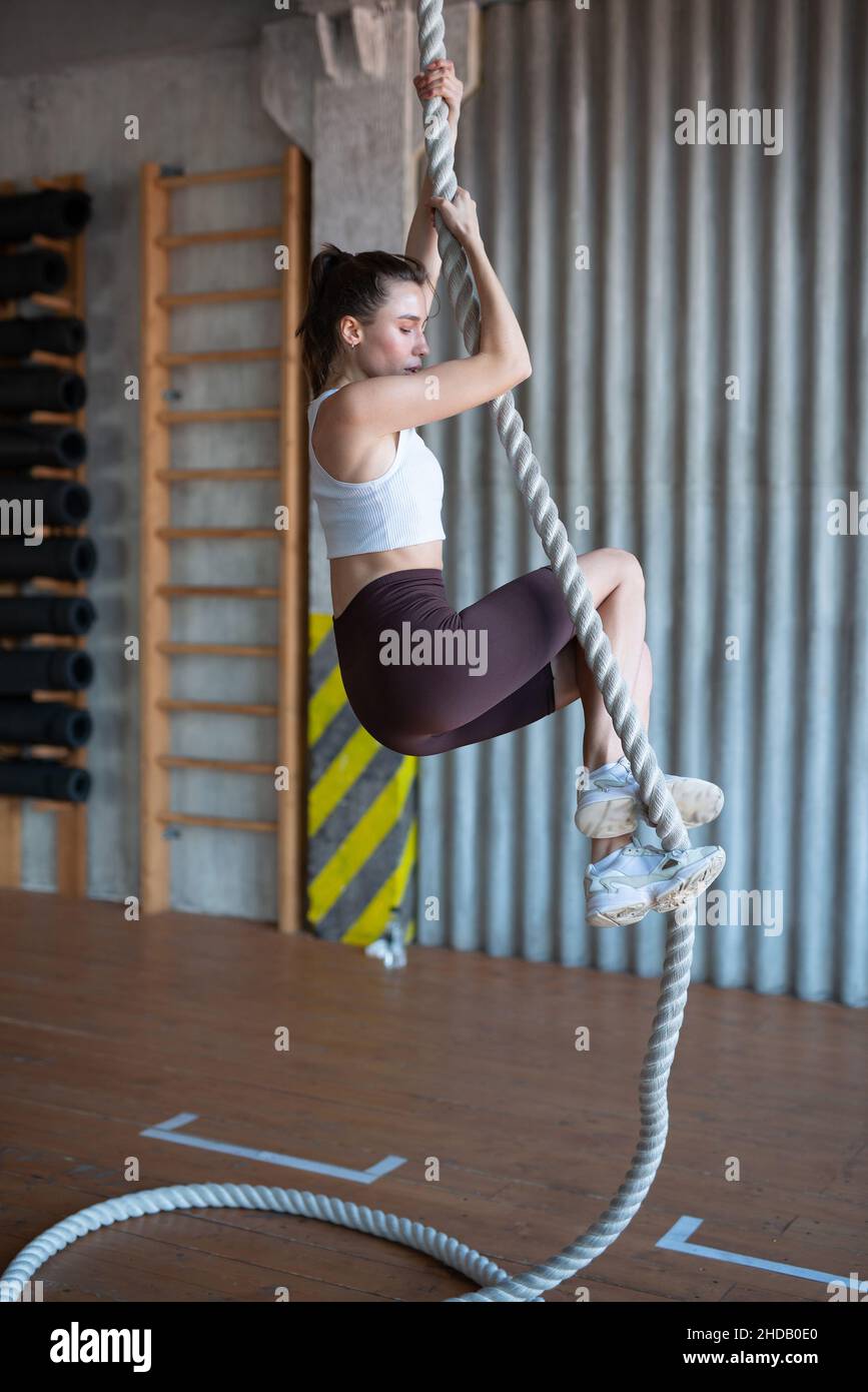 Woman climbing rope hi-res stock photography and images - Alamy