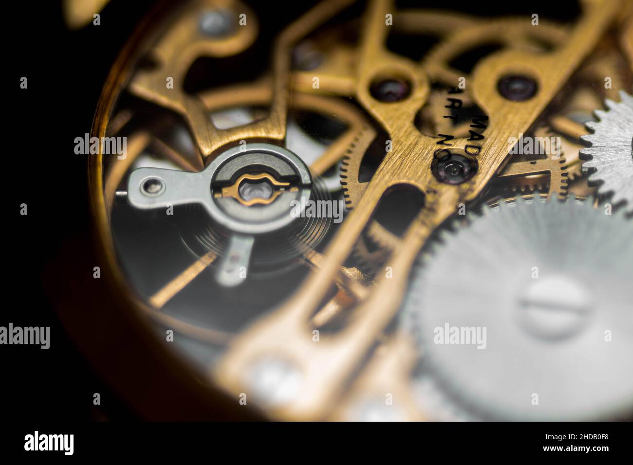 Closeup detail of the internal mechanism of a vintage analog clockwork ...