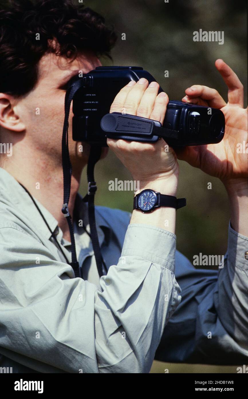 Archives 80ies: A young man with a handycam, France Stock Photo - Alamy