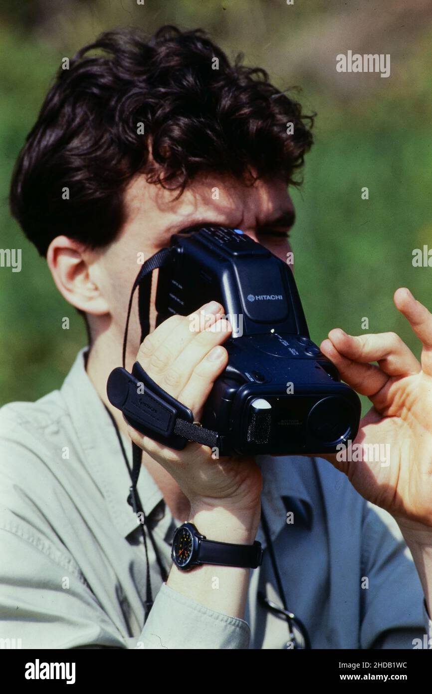 Archives 80ies: A young man with a handycam, France Stock Photo - Alamy