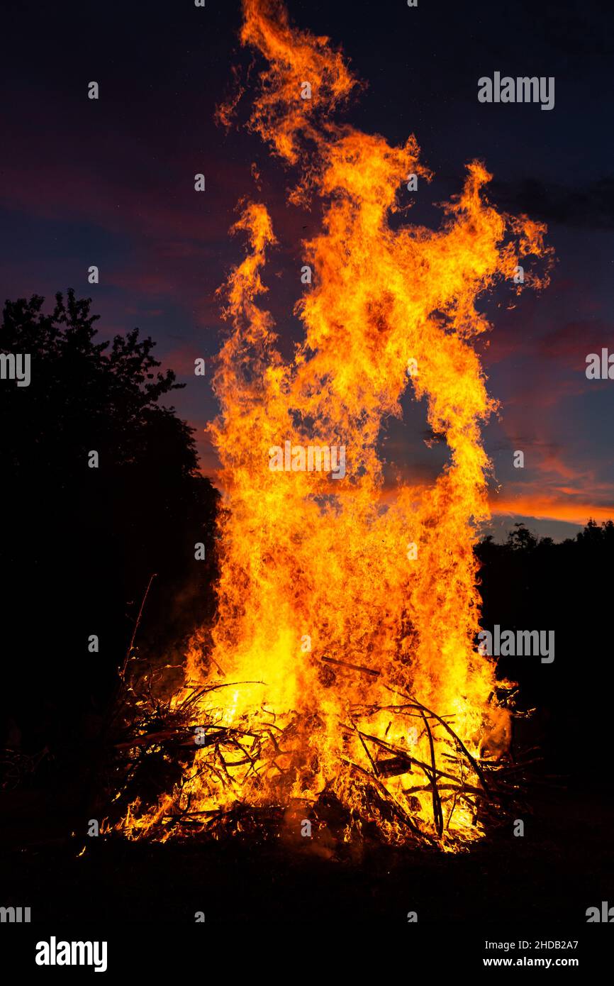burning camp fire in dusk Stock Photo - Alamy