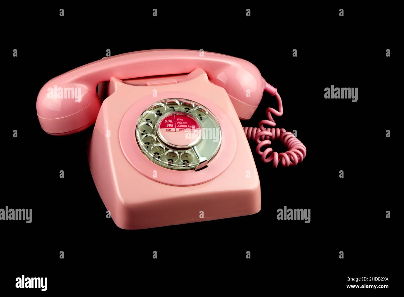 Vintage pink telephone isolated against a black background Stock Photo ...