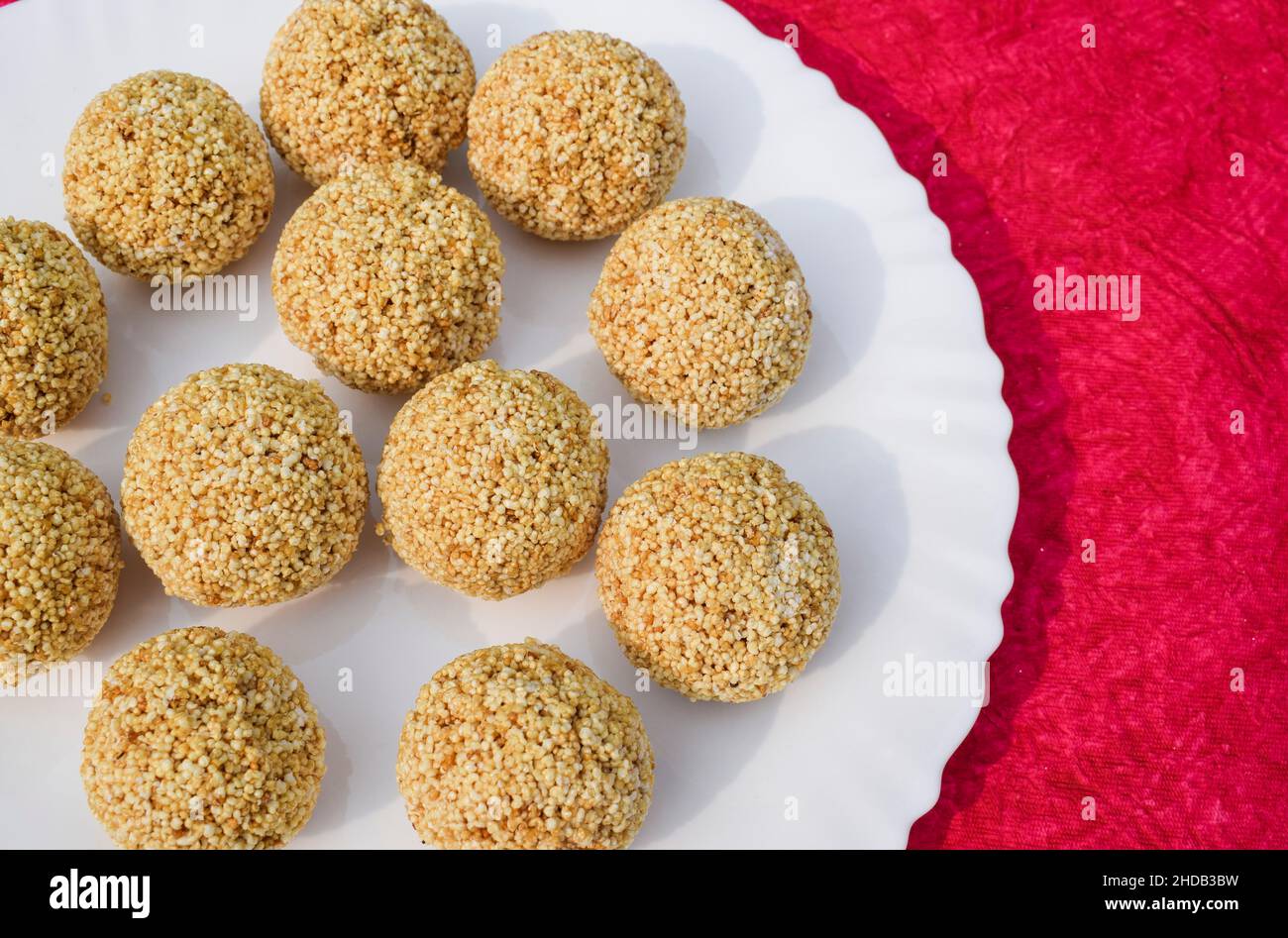 Delicious Rajgira laddu or Amaranth ladoo in white plate on pink ...