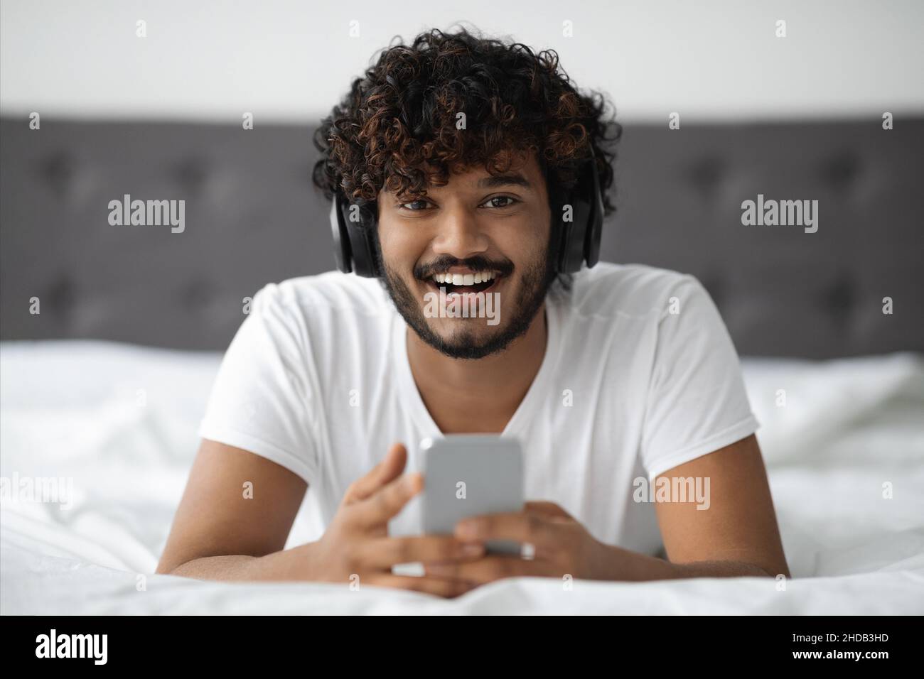 Indian guy listening music headset hi-res stock photography and images ...