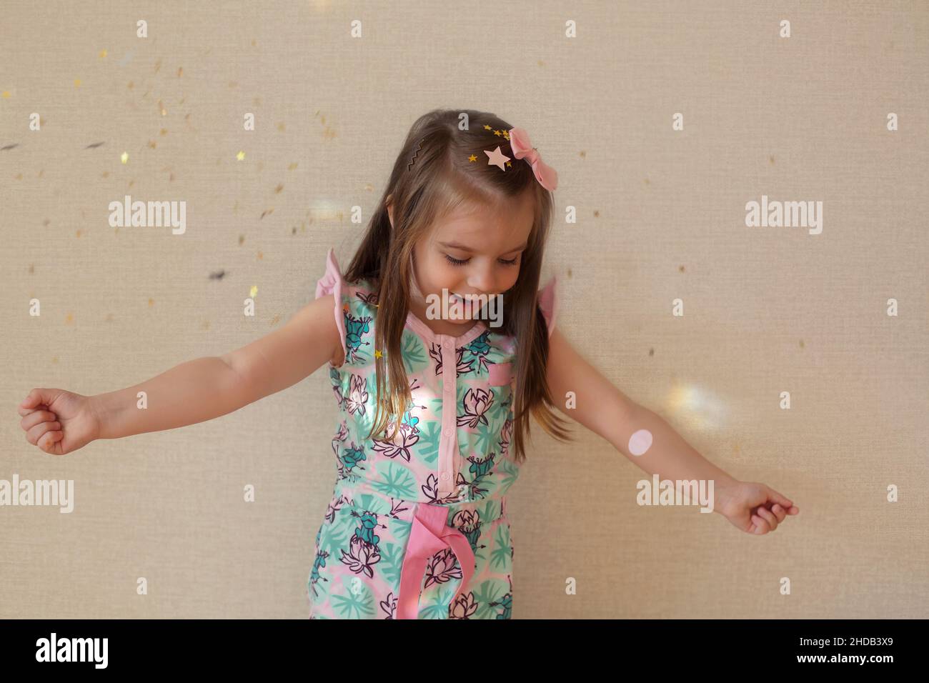 Happy childhood. Excited ecstatic cute adorable little girl throwing ...