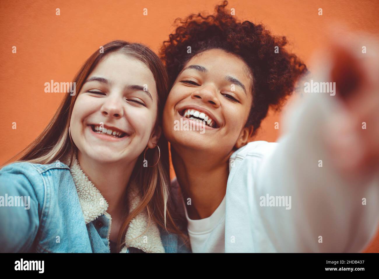 Self-portrait of two happy joyful teen girls of different races smiling ...