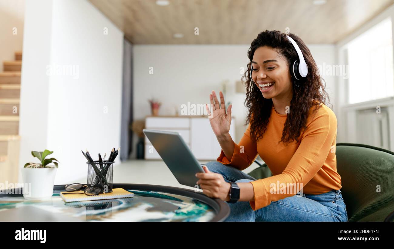 Black woman having video call using tablet and talking Stock Photo - Alamy