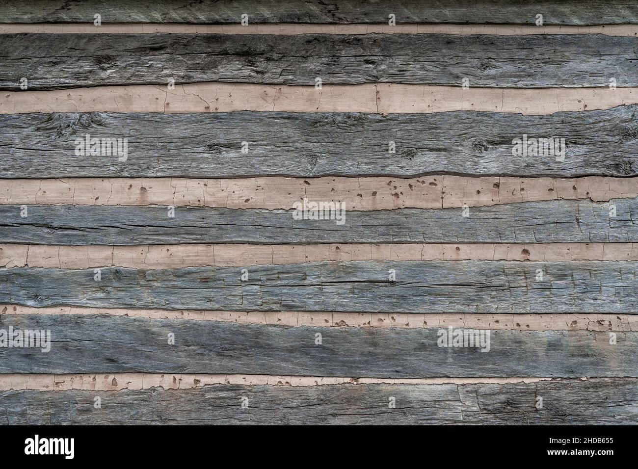 A historic rustic log wall background with all the chinking Stock Photo ...