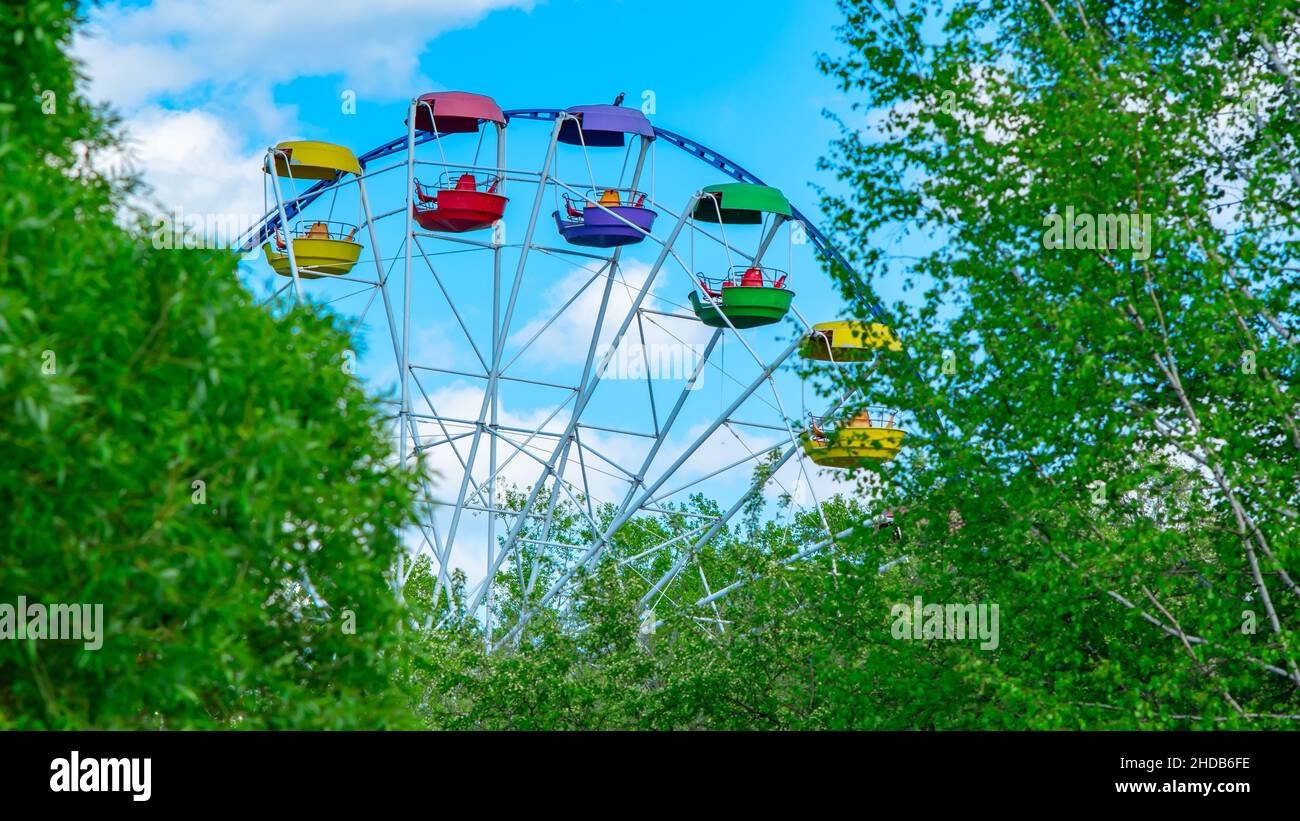view of open colored Ferris wheel booths of the city park Stock Photo ...