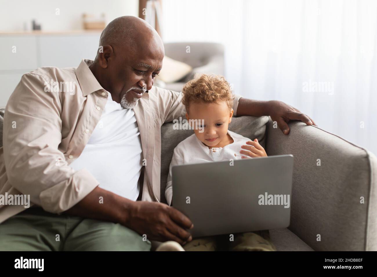 African American Grandpa And Grandson Using Laptop Computer At Home ...