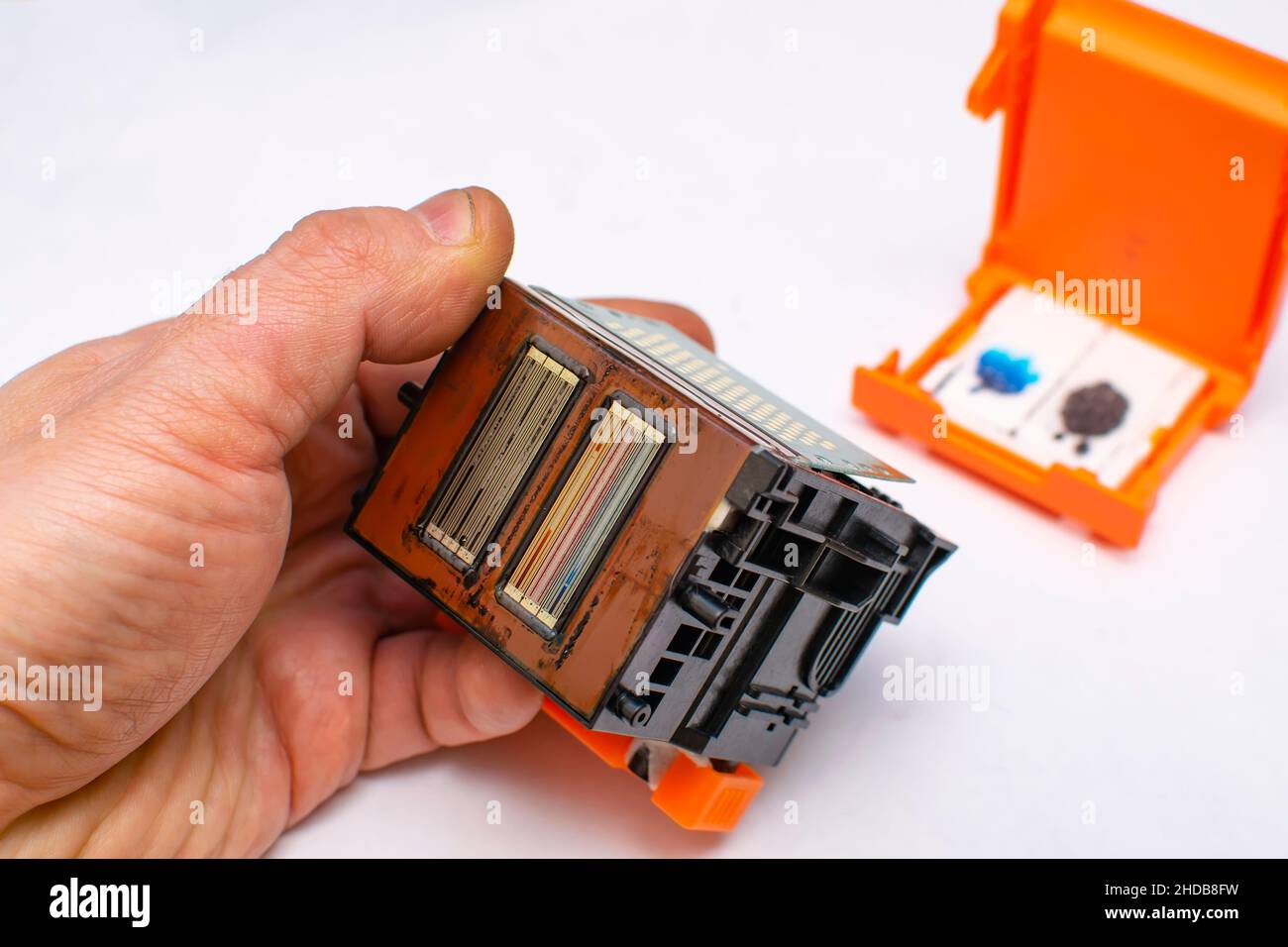 close up, faulty, dirty color ink printhead in the hand of a service ...