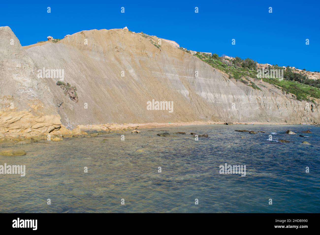 Steep blue clay slopes, with debris forming scree on coastline at Xatt ...