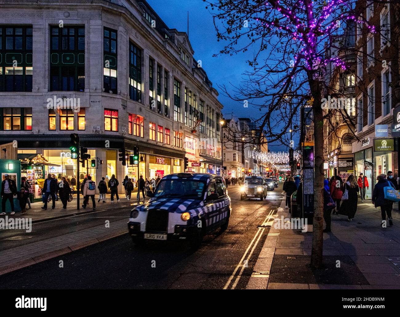 Oxford Street at dusk; a busy shopping street in central London, long ...