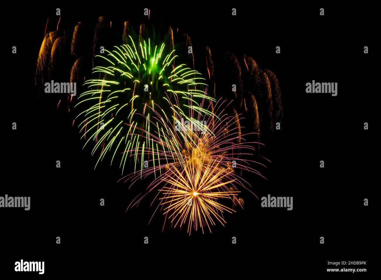 Bright flowers of festive fireworks on a dark background of the night ...