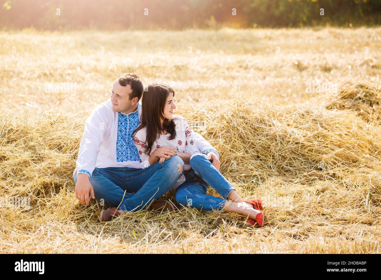 Young couple have a rest in the summer field Stock Photo - Alamy