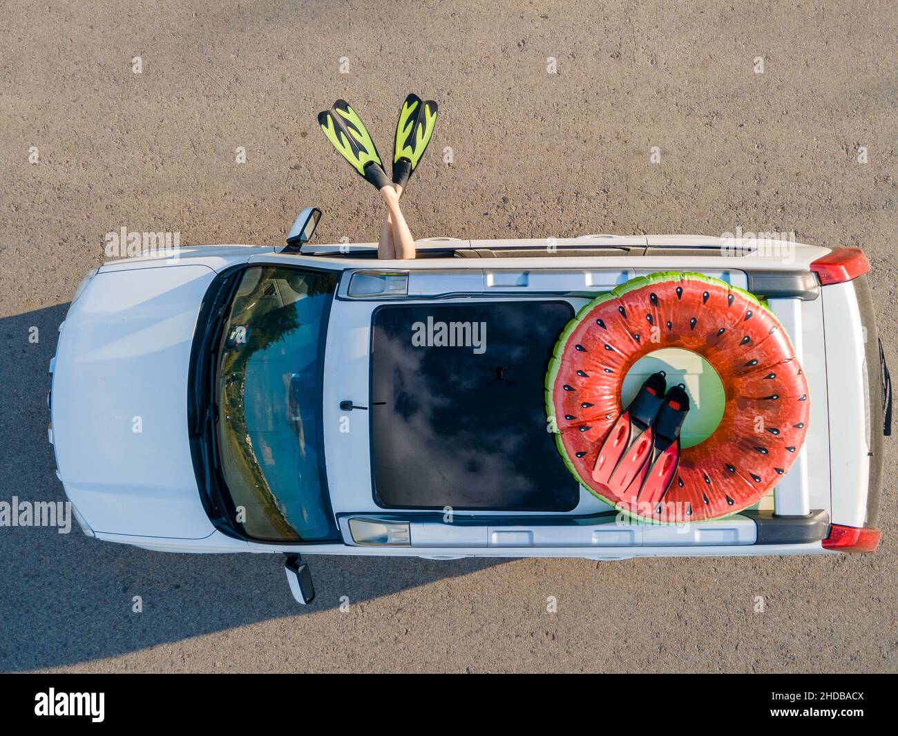 woman legs in flippers stick out from the car window sea vacation ...