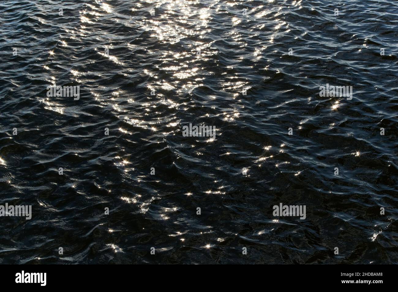 Waves reflect with light in water Stock Photo - Alamy