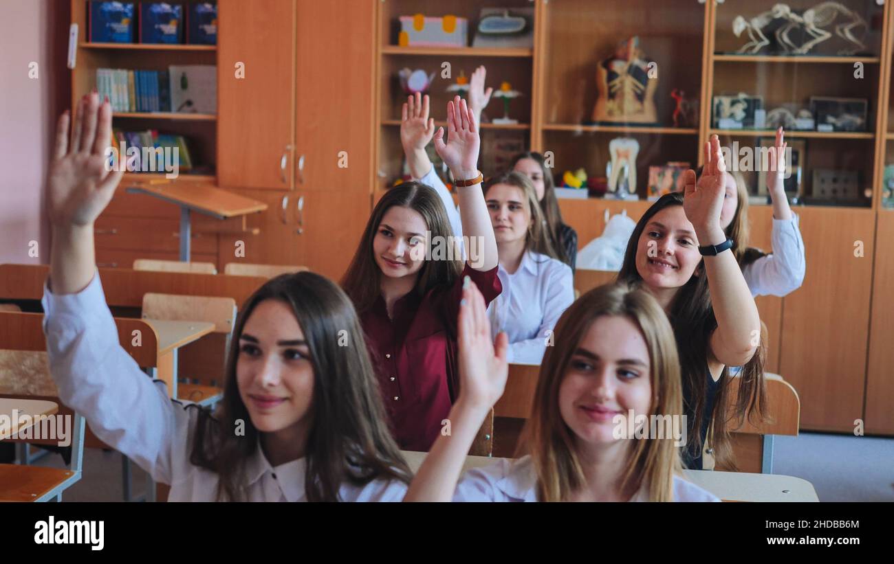High school students stretch their hands in the lesson. Russian school ...