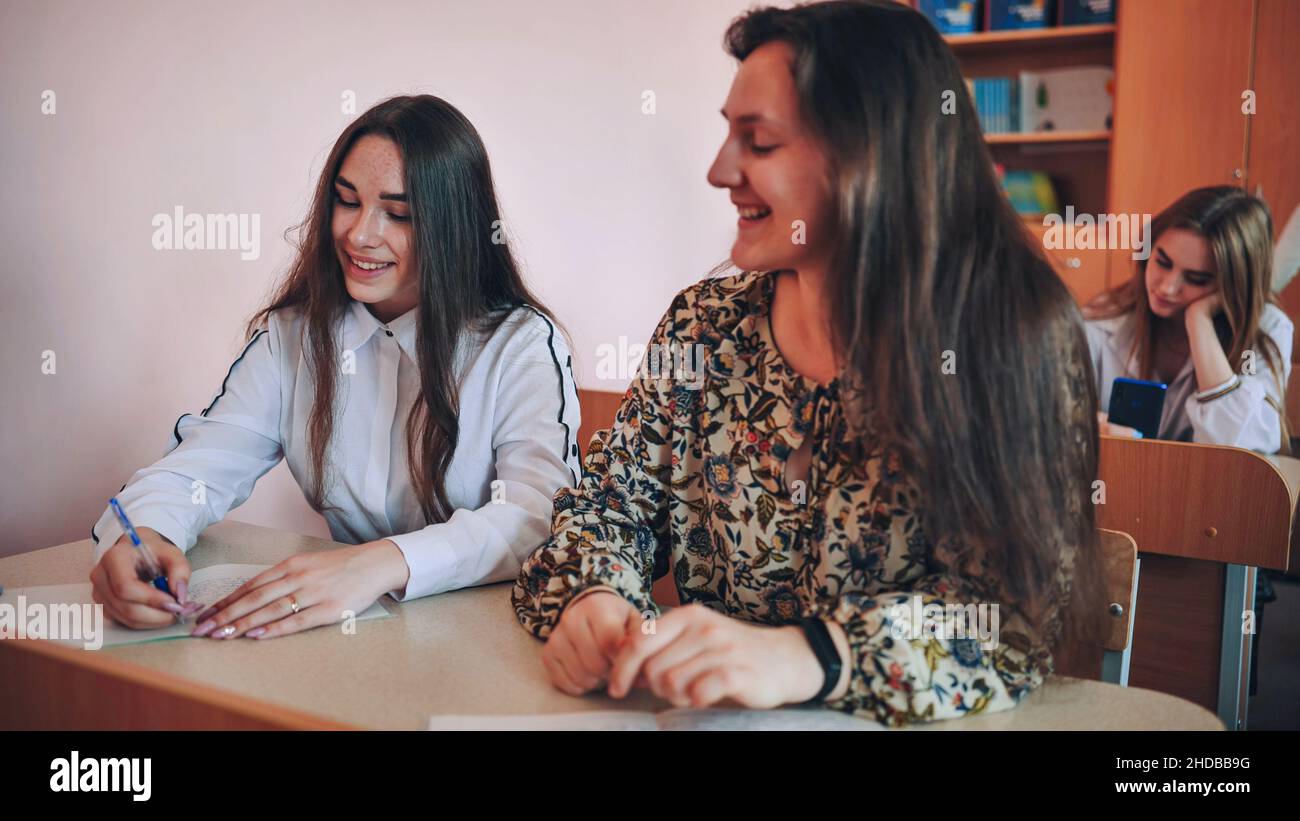Students in the classroom at their desks in front of the're coming out ...